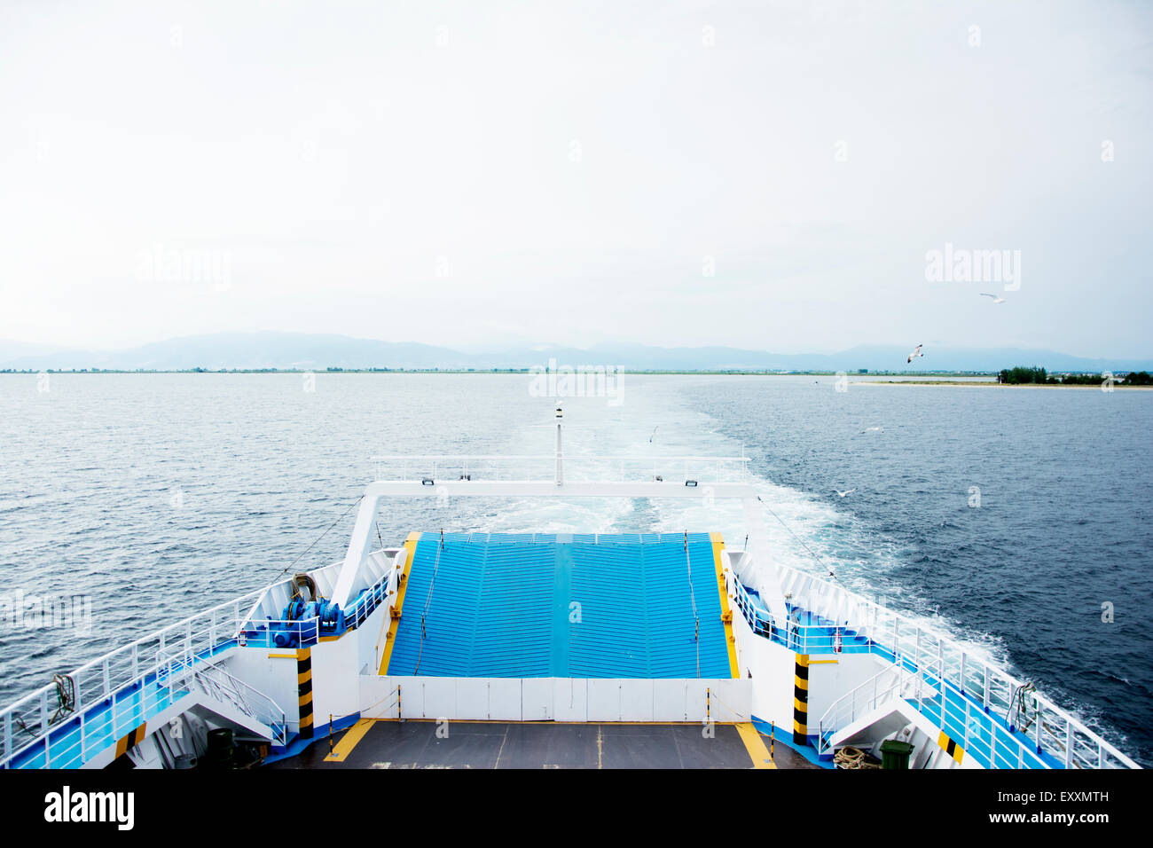 Back side of ferry boat with destination island ahead Stock Photo - Alamy