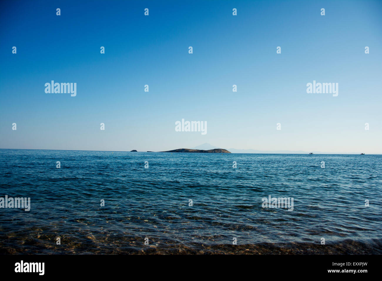 Seascape with island in the middle of clear crystal blue waters Stock ...