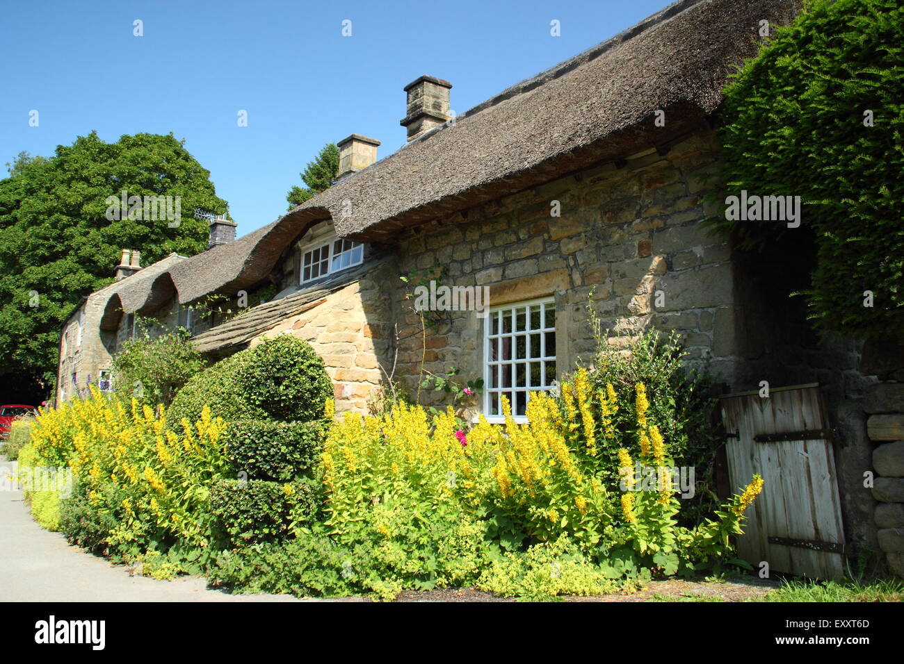 A traditional English thatched cottage in Baslow village the Peak ...