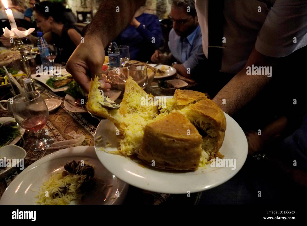 A waiter serving traditional Azerbaijani rice pilaf in a restaurant in ...