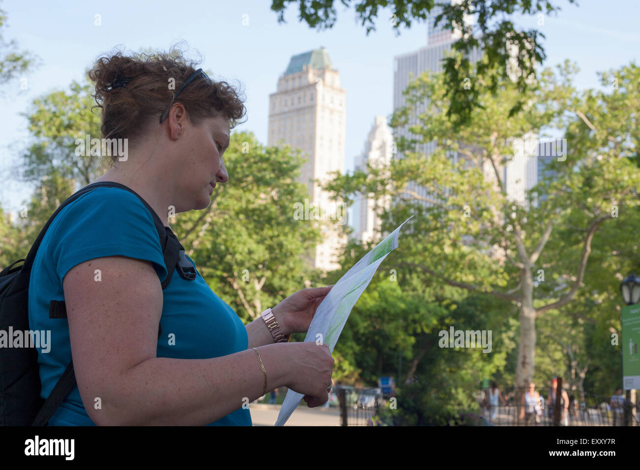 woman reading a map for directions in city while travelling alone Stock ...