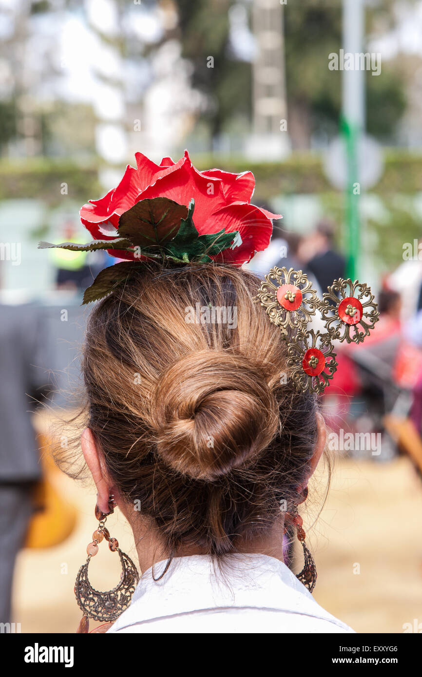 In traditional Seville dress and huge flower in hair in Seville ...