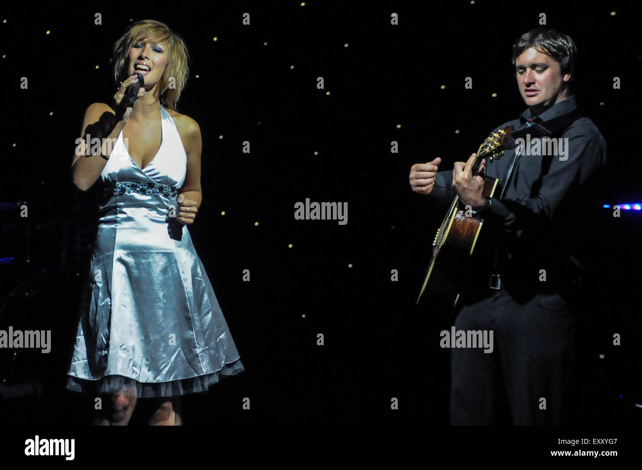 A male and female musician play a song together live on stage. Credit ...