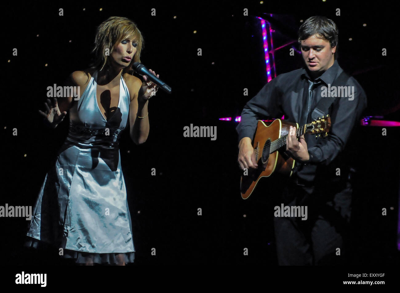 A male and female musician play a song together live on stage. Credit ...