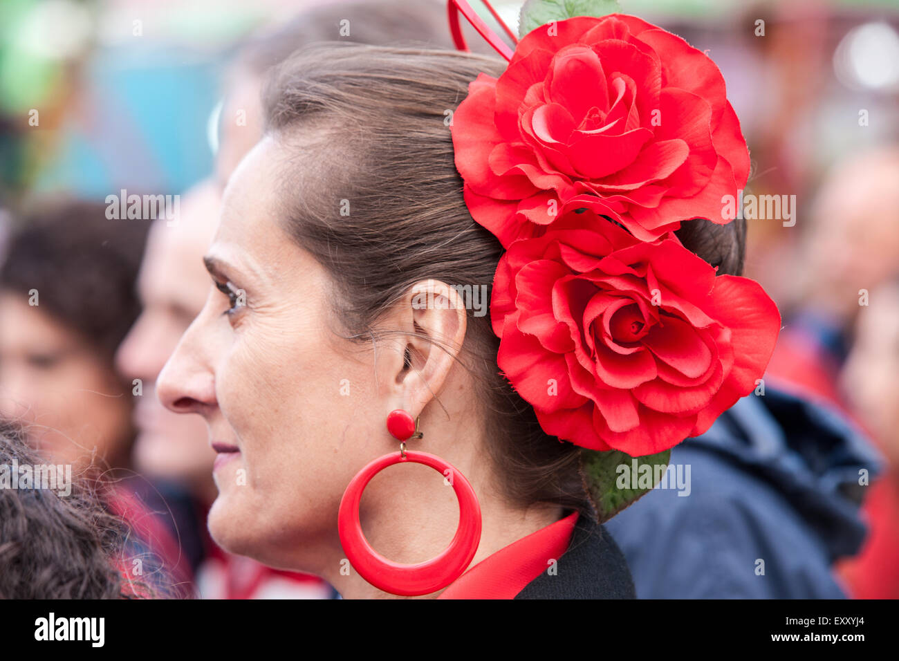 In traditional Seville dress and huge flowers in hair in Seville ...