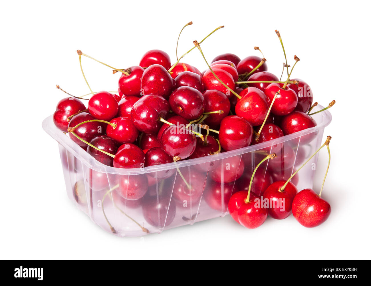 Sweet cherries in plastic tray and three near top view isolated on ...