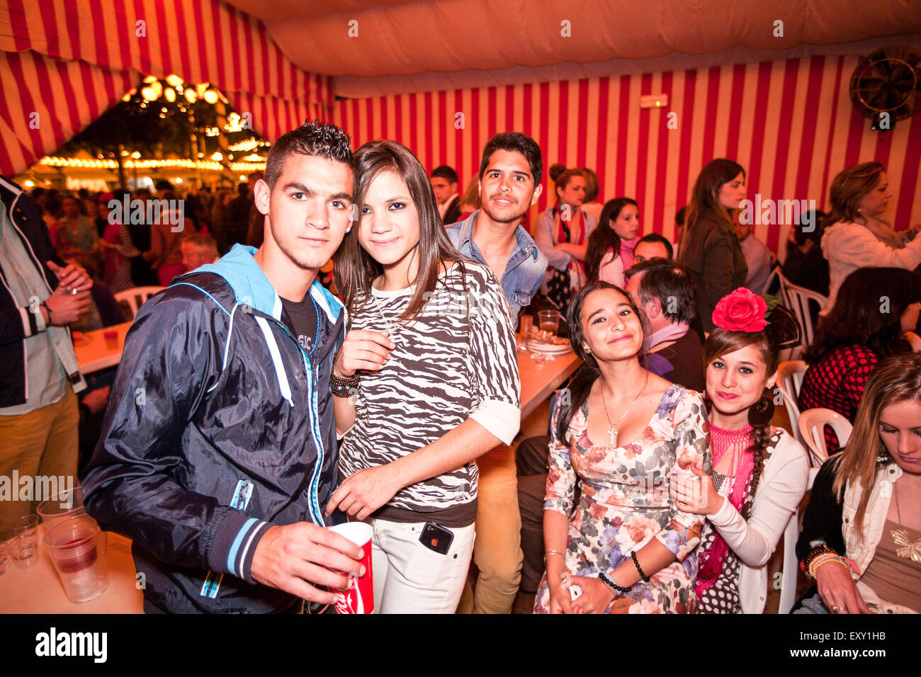 Spanish youths in large tent used by general public. In Seville ...