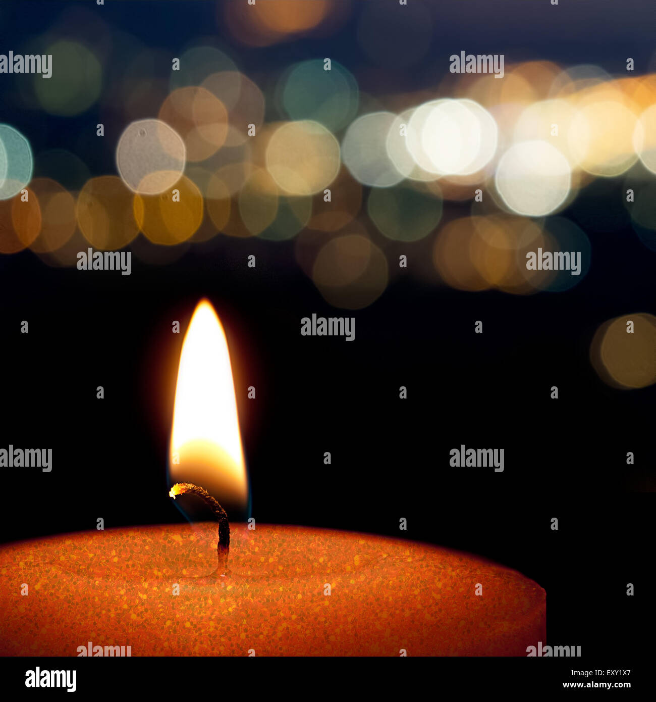 Christmas candle with lights behind. Square crop Stock Photo - Alamy