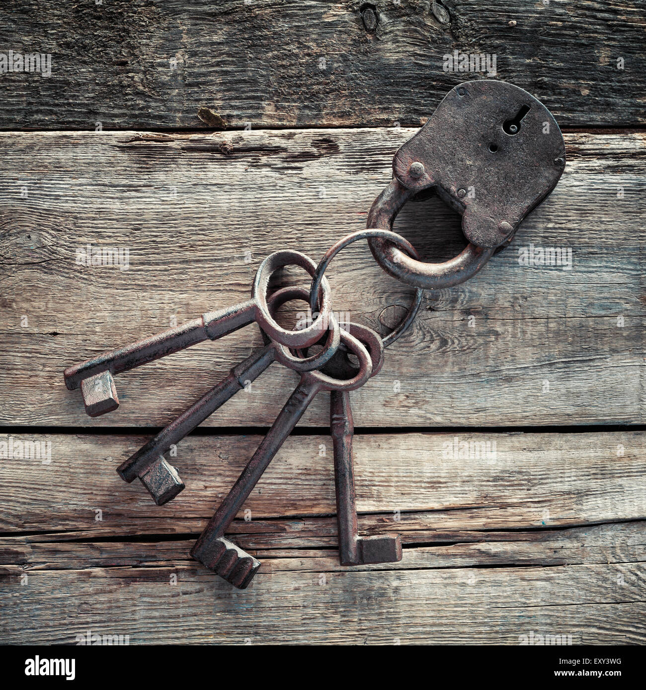 Old rusty lock with keys on wooden background Stock Photo - Alamy