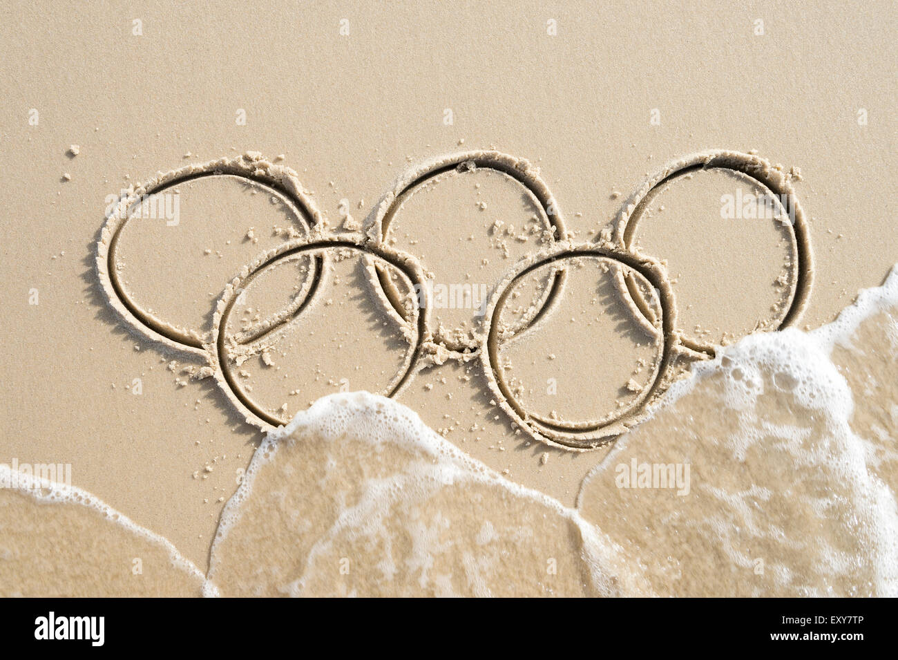 RIO DE JANEIRO, BRAZIL - MARCH 20, 2015: Wave approaches Olympic rings ...