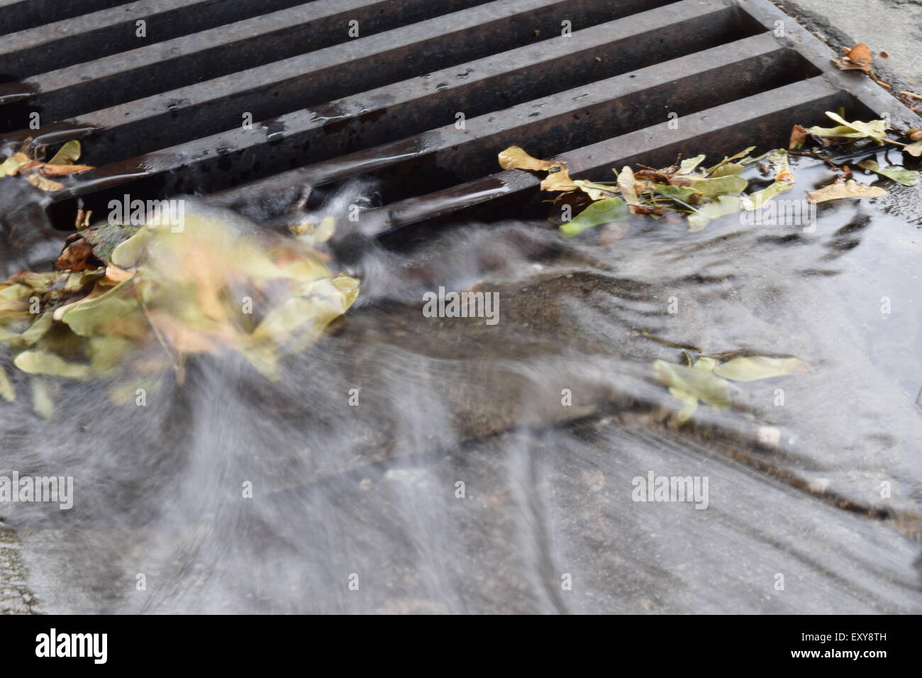 Water flowing into a gutter Stock Photo - Alamy