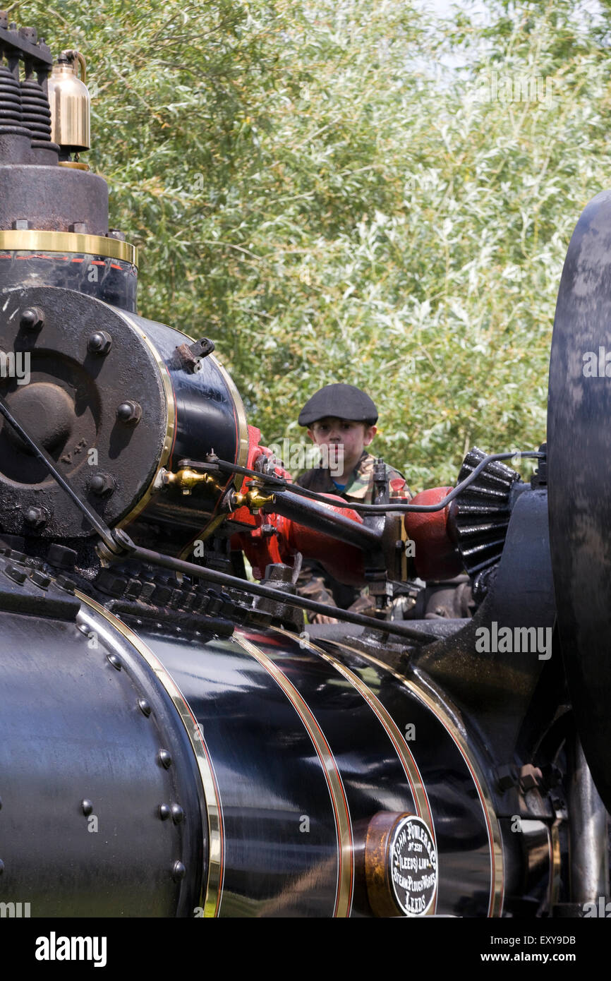 Coal boy working a steam engine Stock Photo - Alamy
