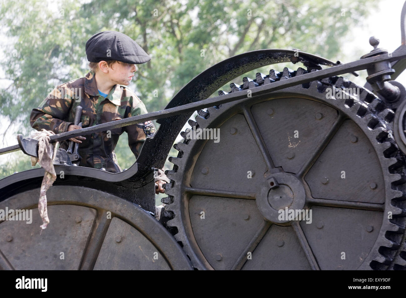 Coal boy working a steam engine Stock Photo - Alamy