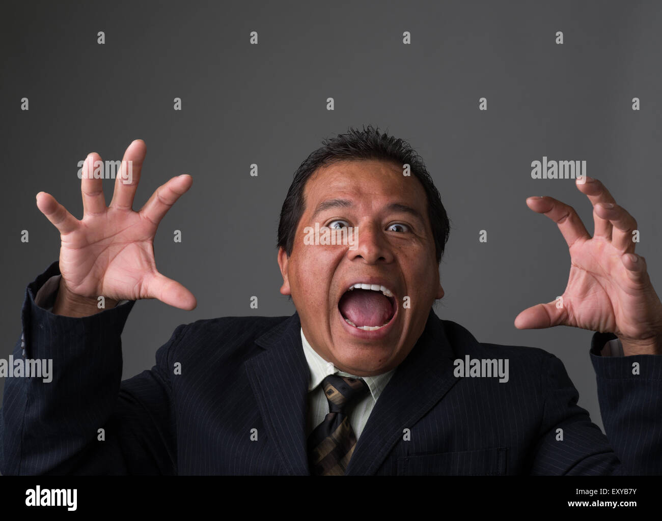 A Hispanic businessman looking scared and fearful Stock Photo - Alamy