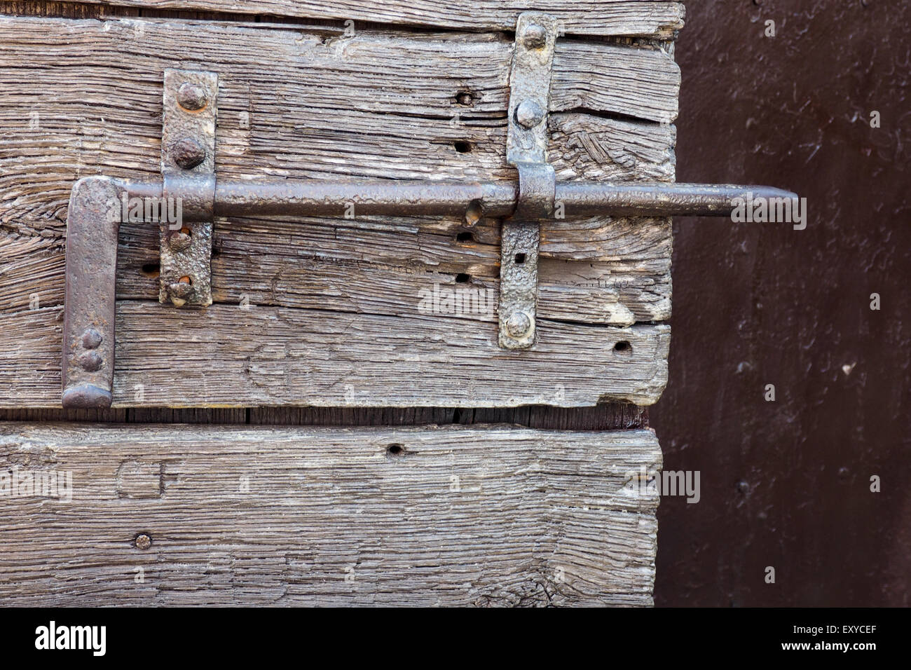 Rustic metal bolt on a weathered wooden door Stock Photo - Alamy