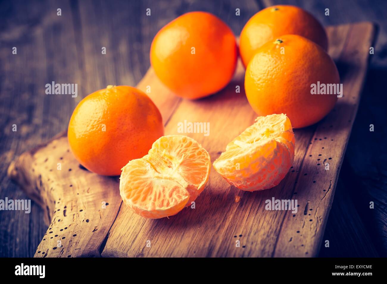 Vintage photo of fresh tangerines on wooden cutting board. Photo with ...
