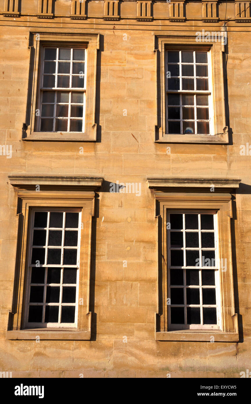 Four windows in a Georgian house made of golden Bath Stone Stock Photo ...