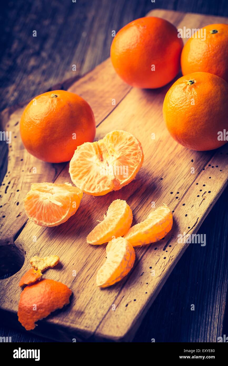 Vintage photo of fresh tangerines on wooden cutting board. Photo with ...