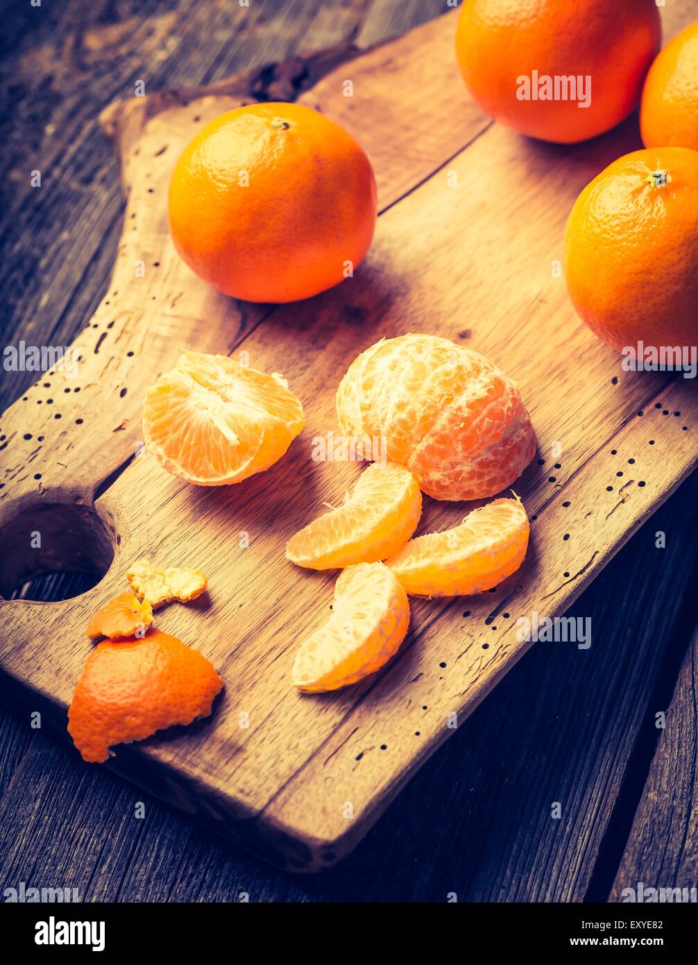Vintage photo of fresh tangerines on wooden cutting board. Photo with ...
