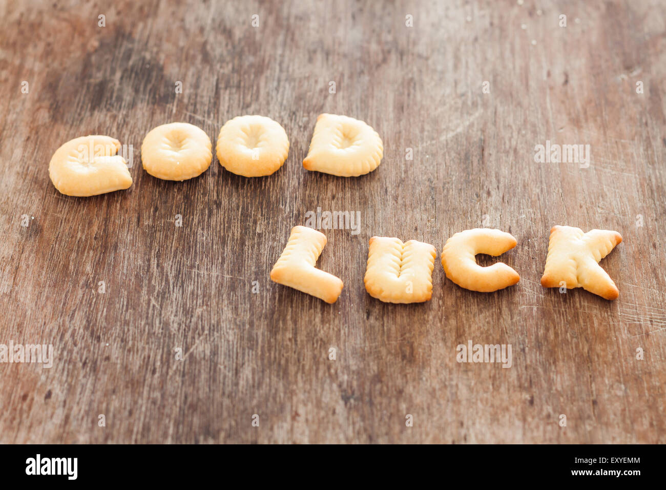Good luck alphabet biscuit on wooden table, stock photo Stock Photo - Alamy