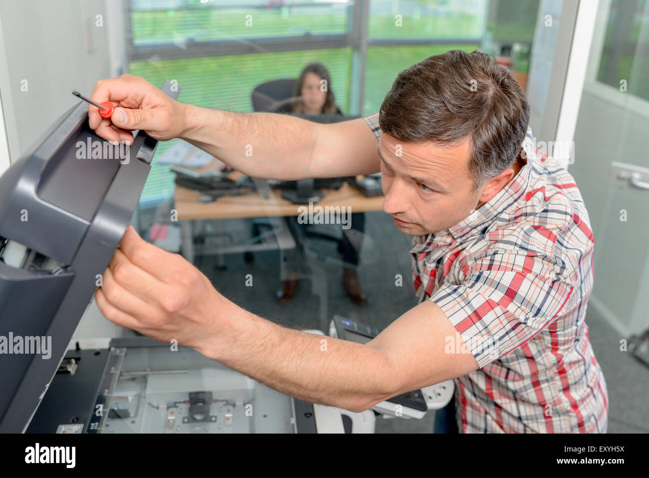 Trying to repair the office printer Stock Photo - Alamy