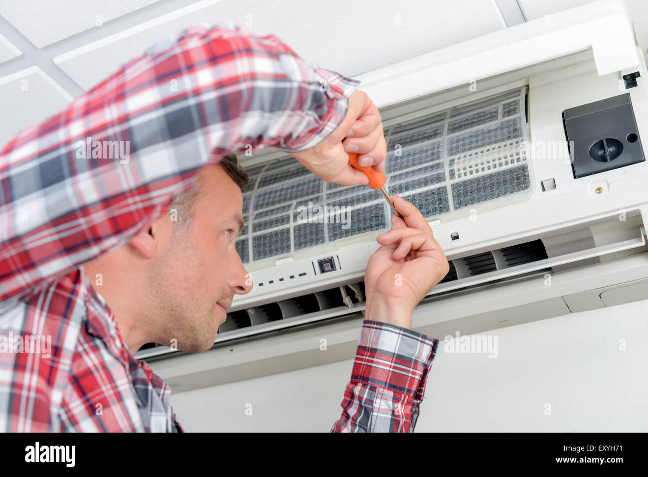man working on air conditioning unit Stock Photo - Alamy