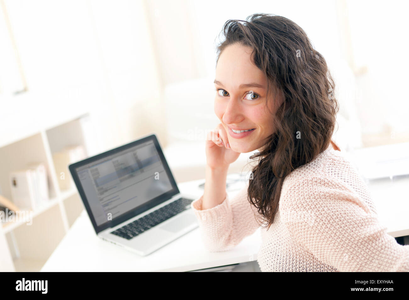 View of young smiling business woman at work Stock Photo - Alamy