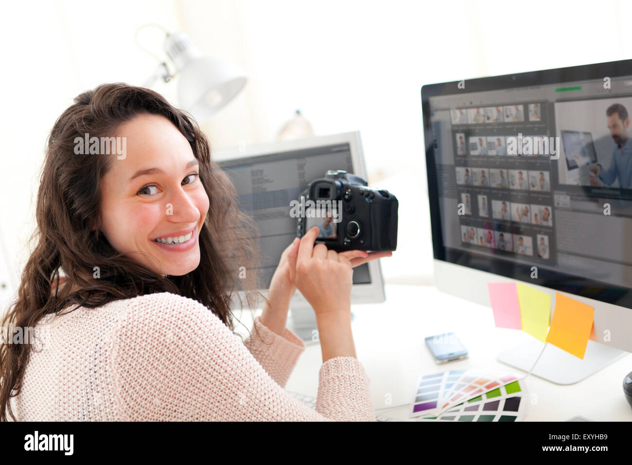 View of Young woman photographer watching pictures on camera Stock ...