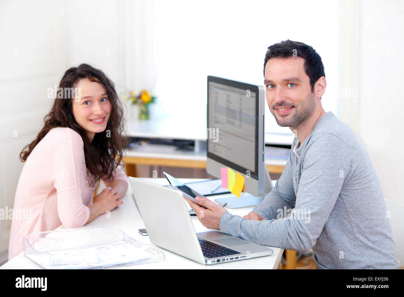 View of Young attractive co-workers at the office Stock Photo - Alamy