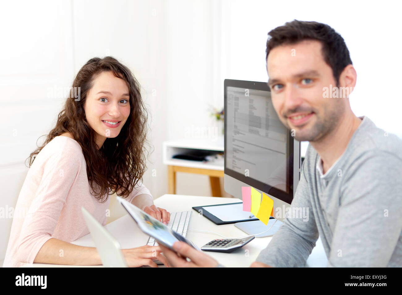View of Young attractive co-workers at the office Stock Photo - Alamy