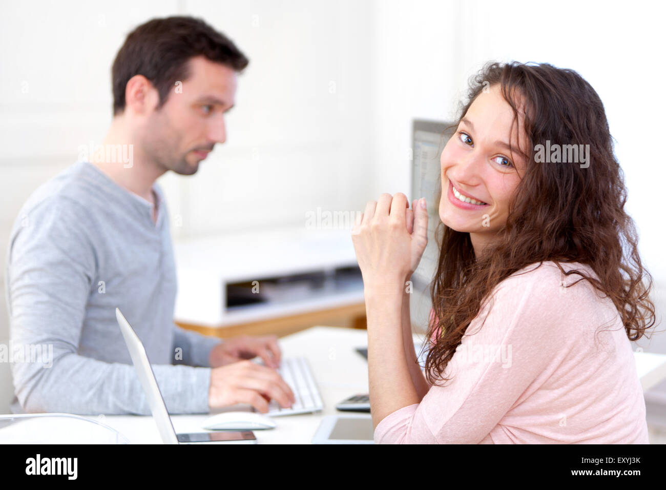 View of Young attractive co-workers at the office Stock Photo - Alamy
