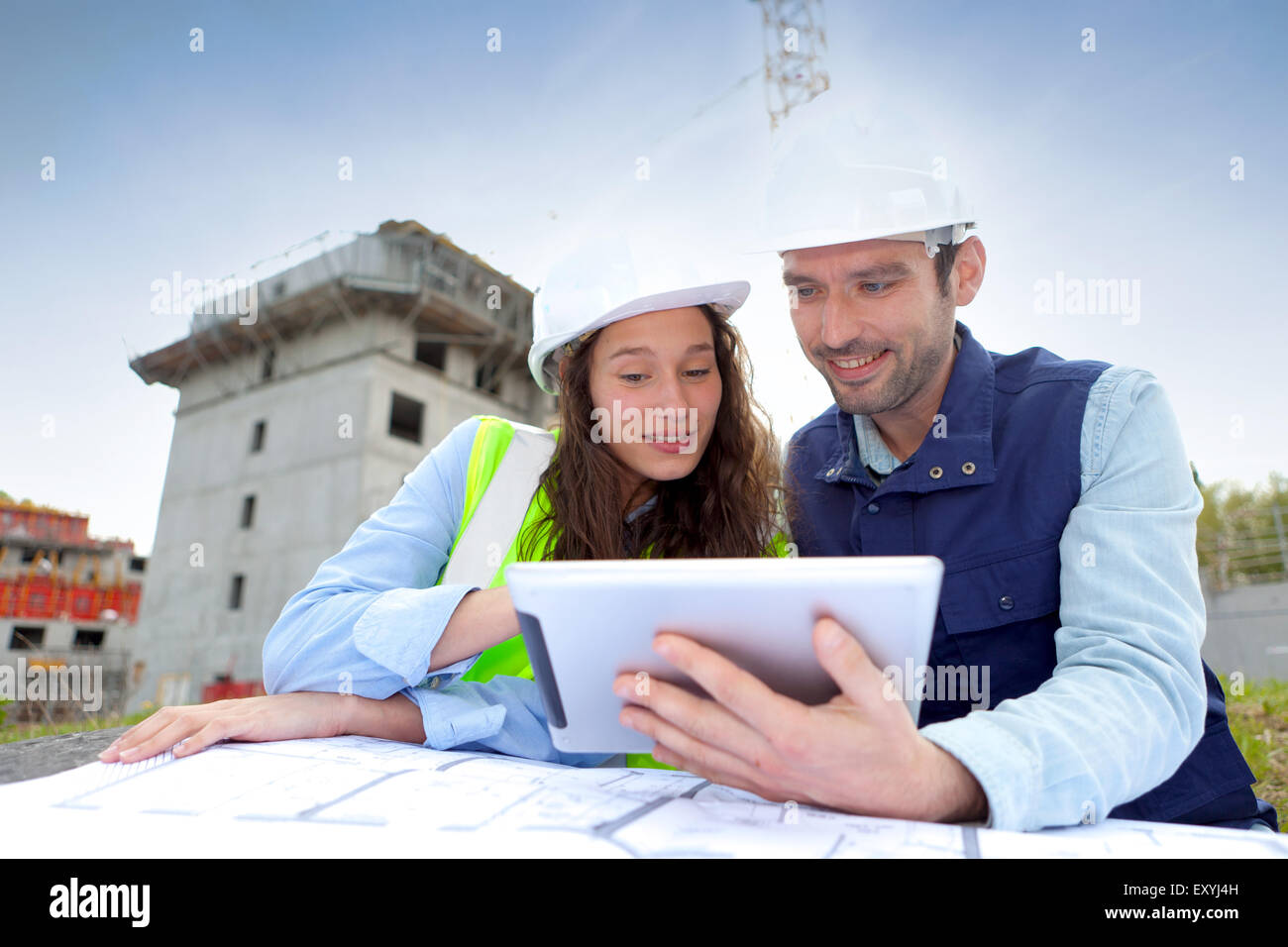 View of Co-workers working on a construction site Stock Photo - Alamy