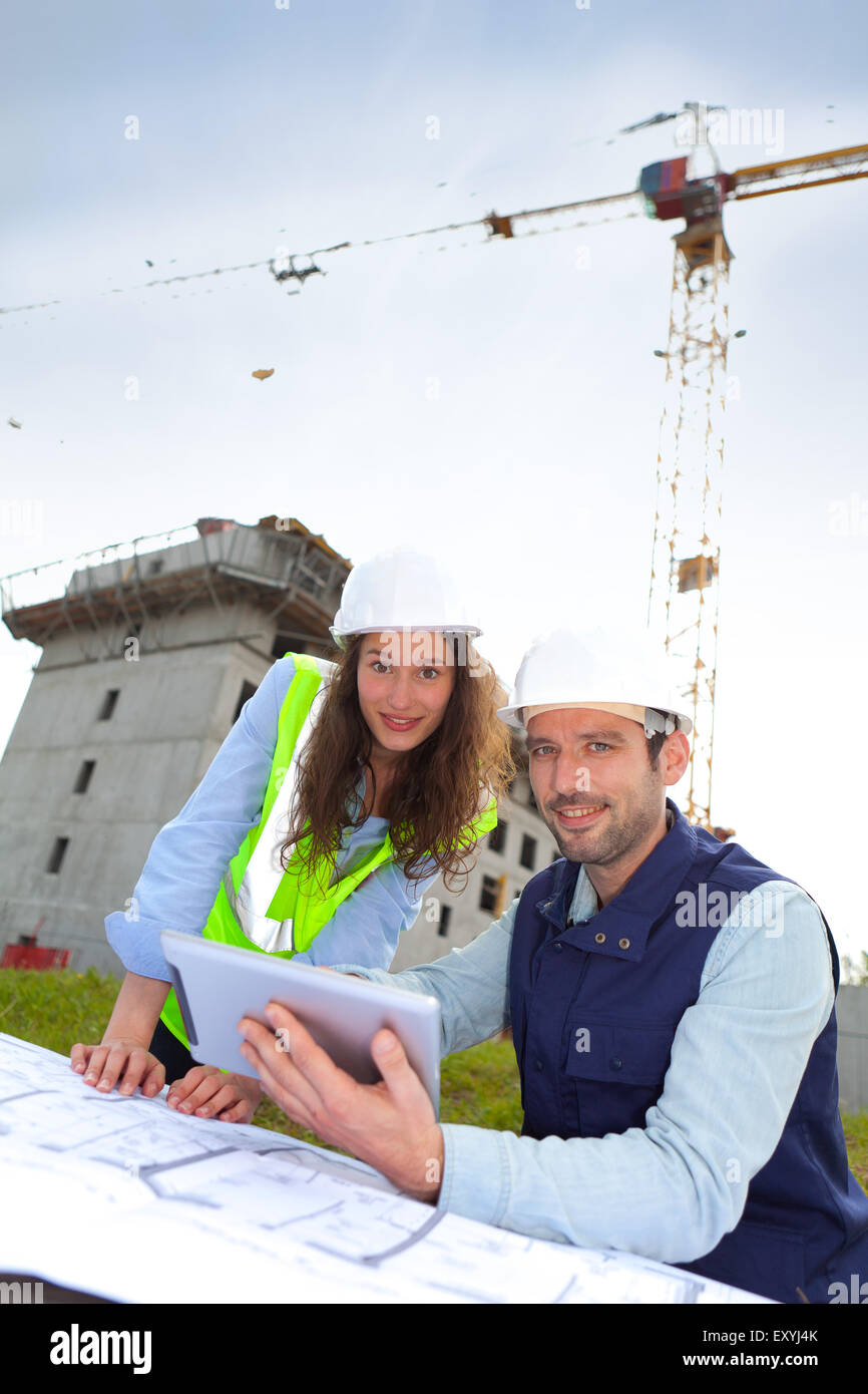 View of Co-workers working on a construction site Stock Photo - Alamy