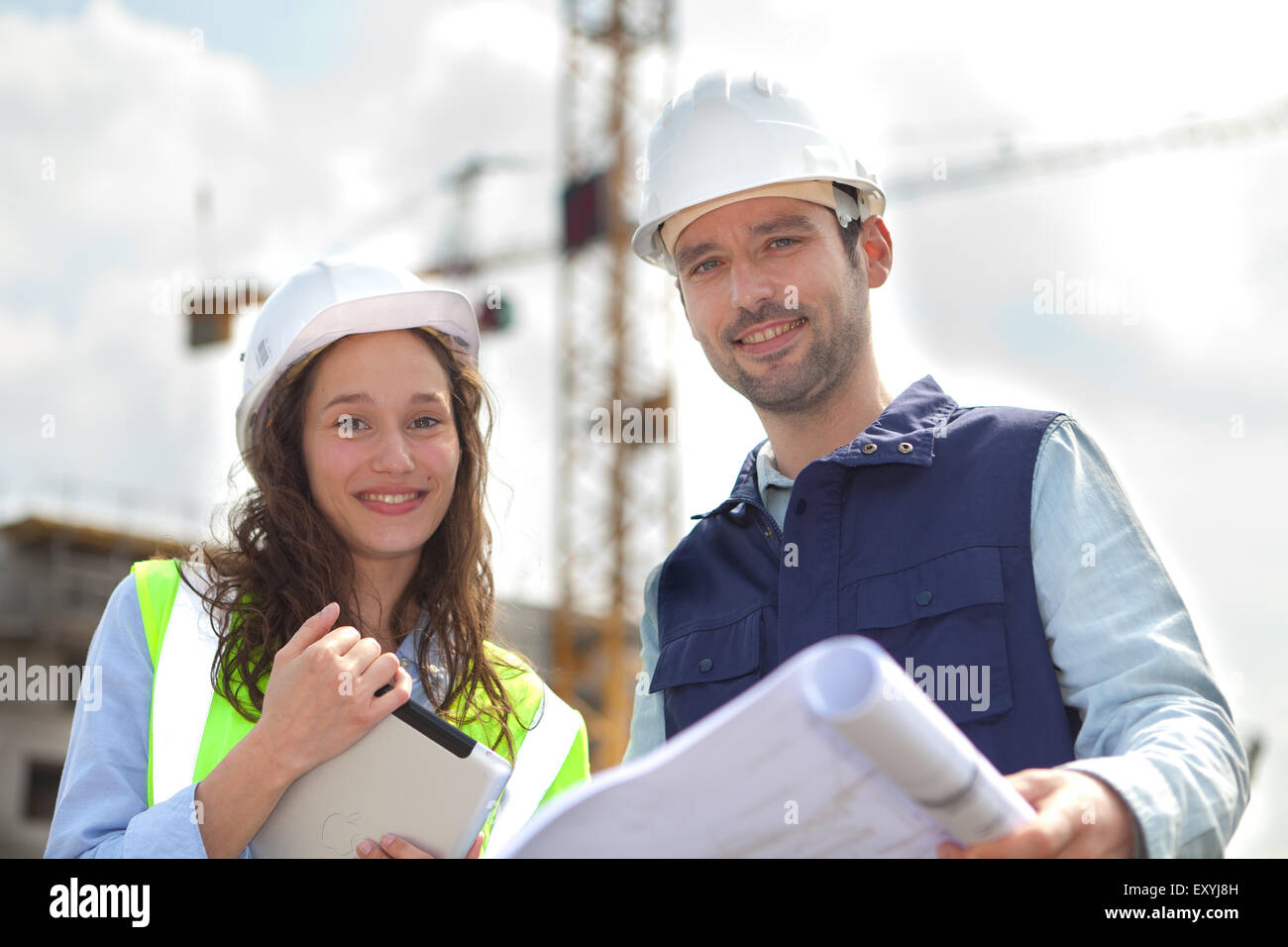 View of Co-workers working on a construction site Stock Photo - Alamy