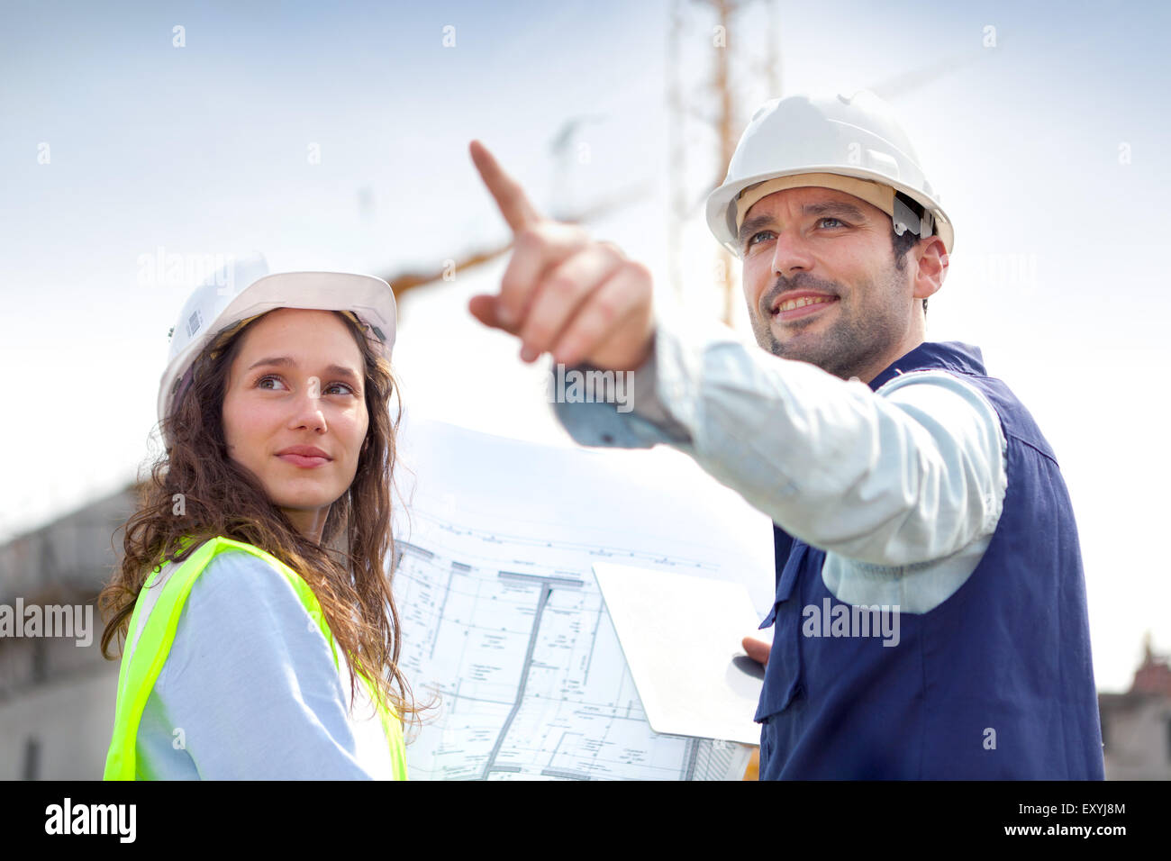 View of Co-workers working on a construction site Stock Photo - Alamy