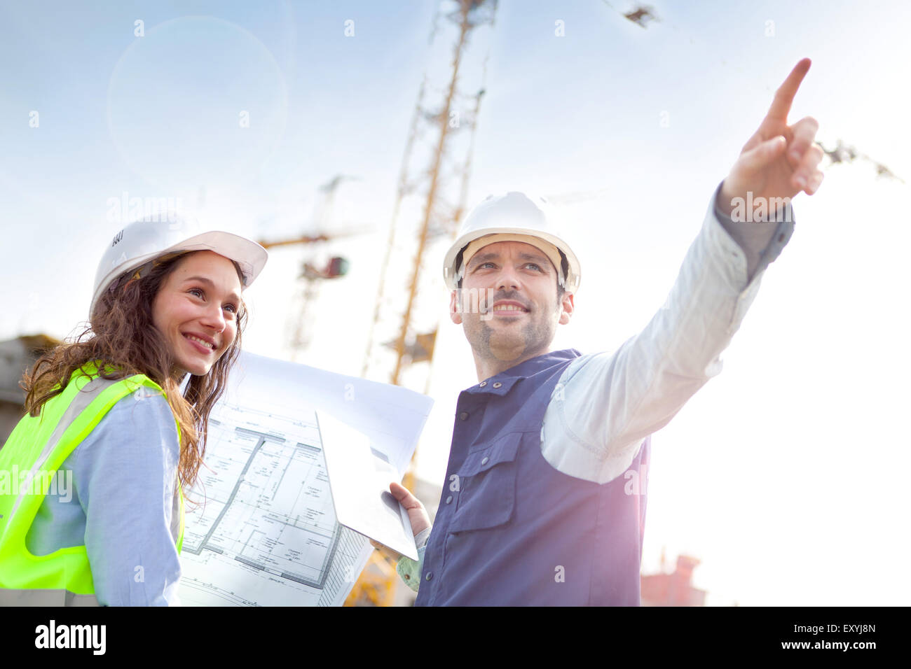 View of Co-workers working on a construction site Stock Photo - Alamy