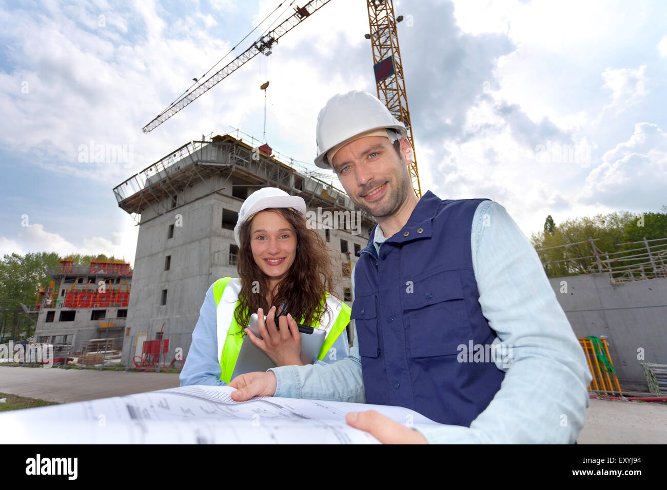 View of Co-workers working on a construction site Stock Photo - Alamy