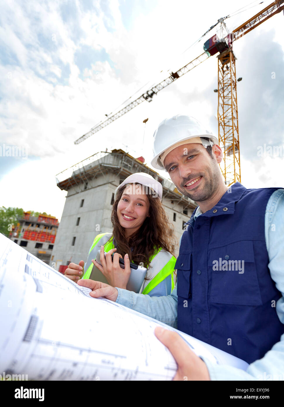 View of Co-workers working on a construction site Stock Photo - Alamy