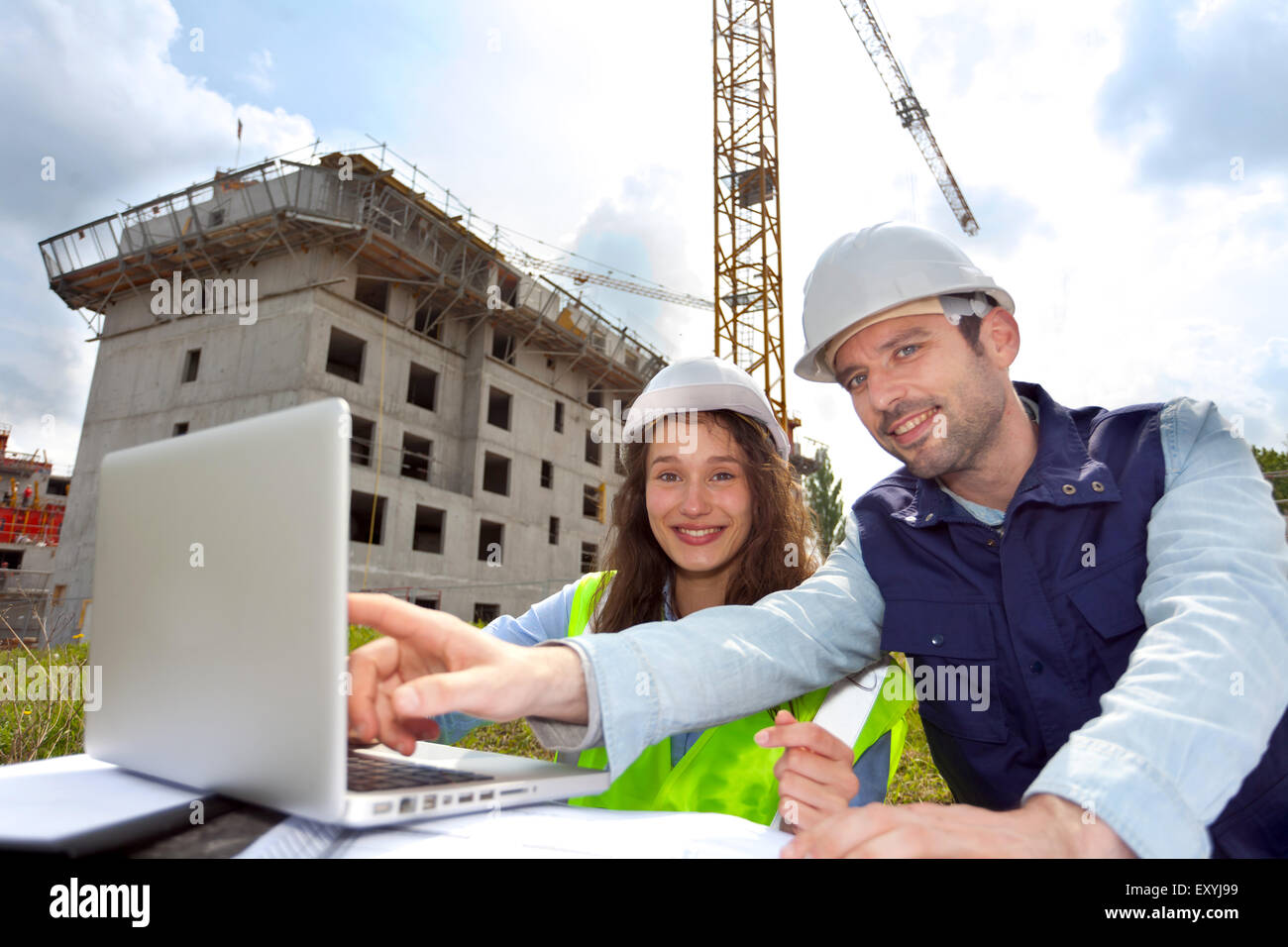 View of Co-workers working on a construction site Stock Photo - Alamy