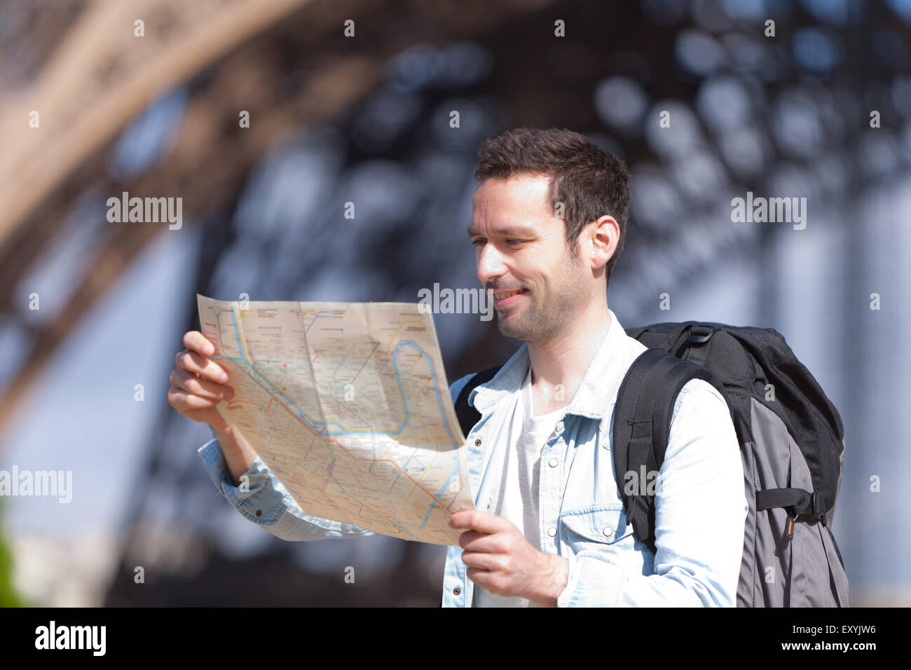 Young attractive tourist reading map in Paris, France Stock Photo - Alamy
