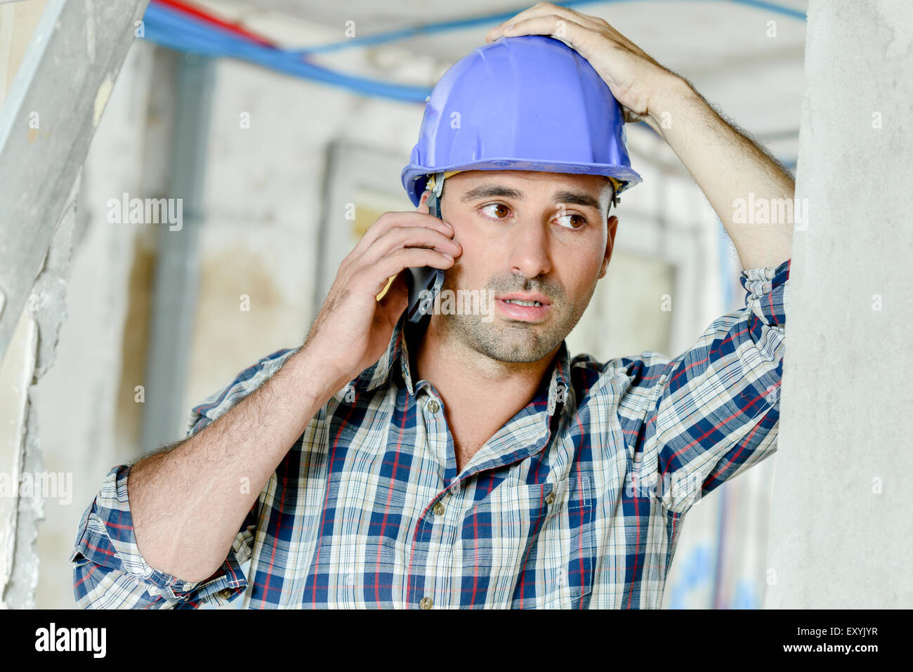 Builder on telephone stressed hi-res stock photography and images - Alamy