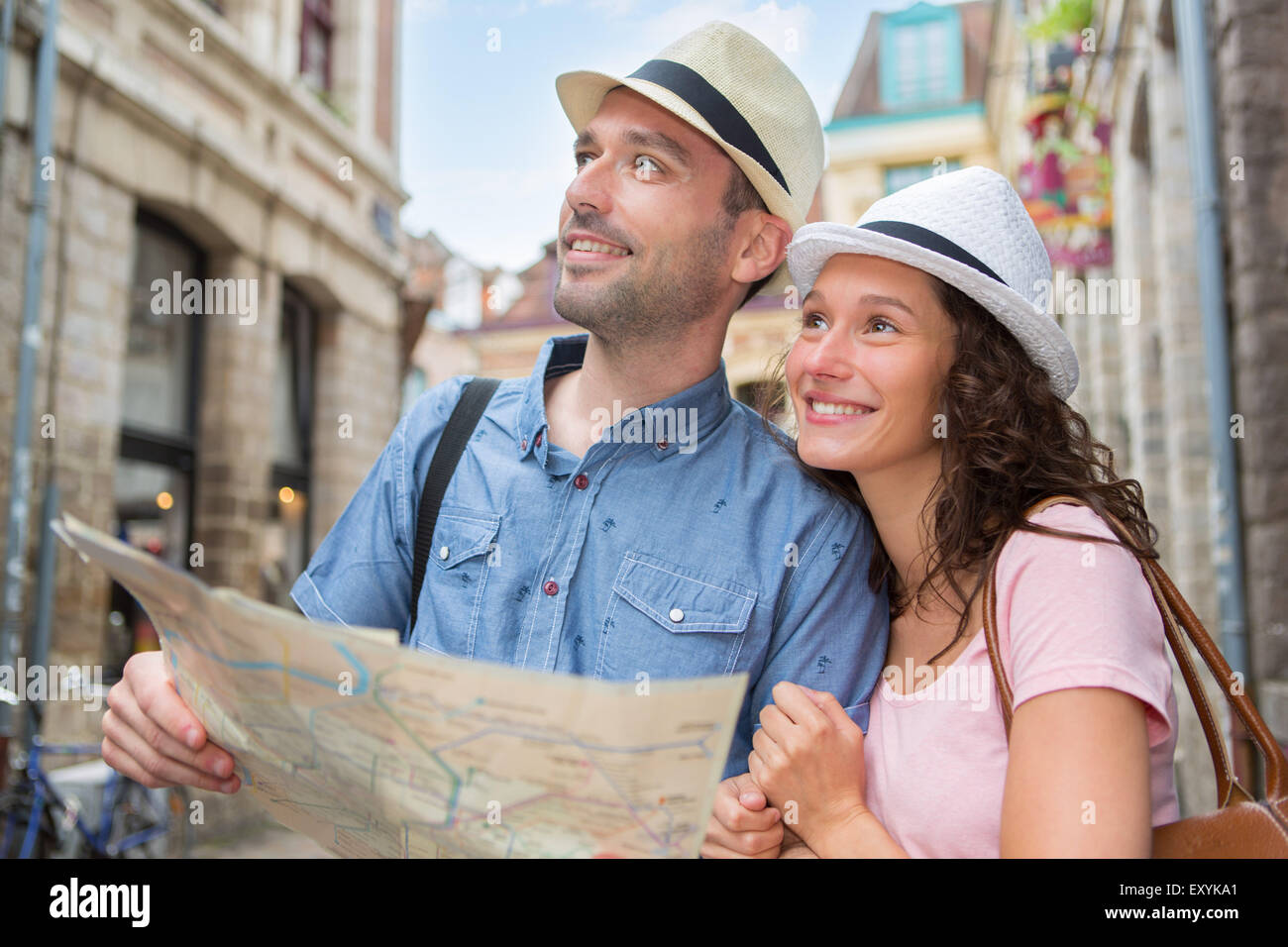View of a Couple of young attractive tourists watching map Stock Photo ...
