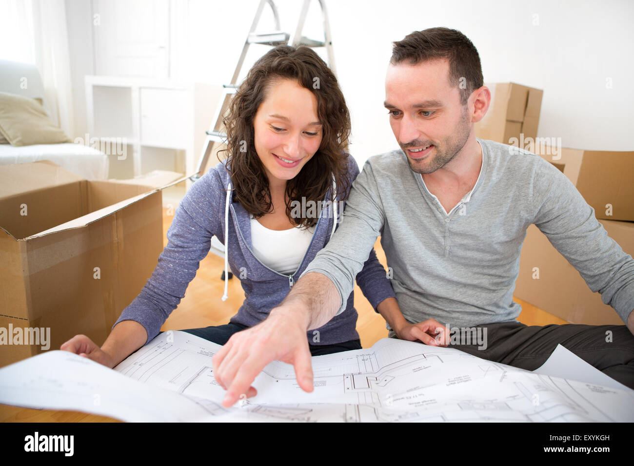 View of a Young couple watching plans in their new flat Stock Photo - Alamy