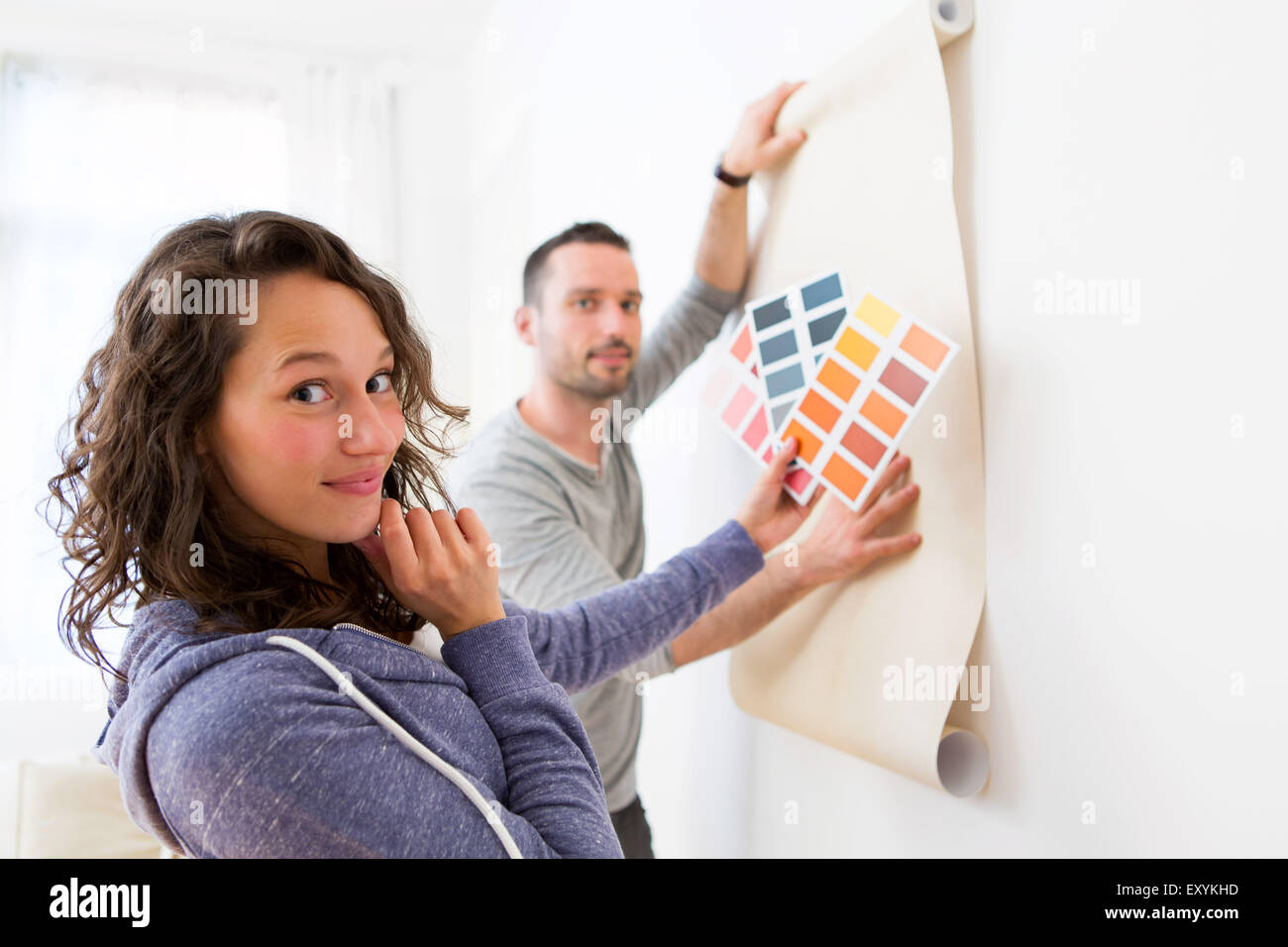 View of a Young couple choosing colors of their wallpaper Stock Photo ...