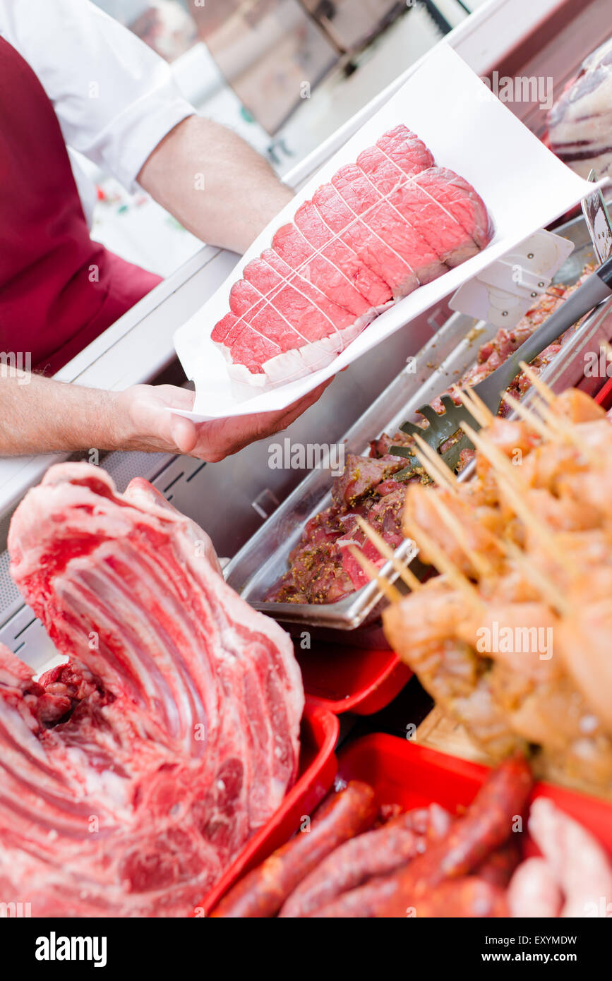 Butcher holding beef Stock Photo - Alamy