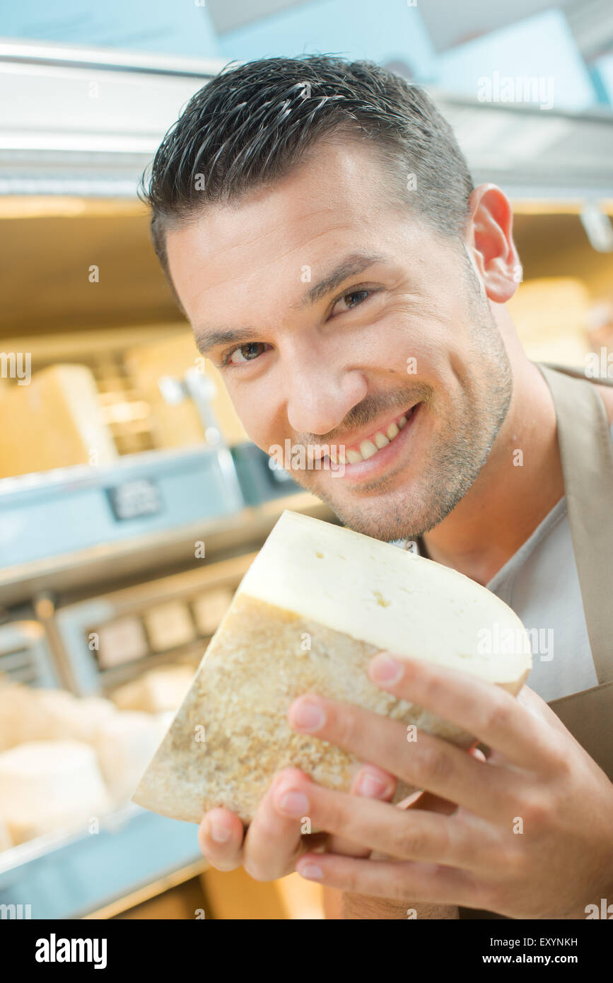 Man holding chunk of cheese Stock Photo - Alamy