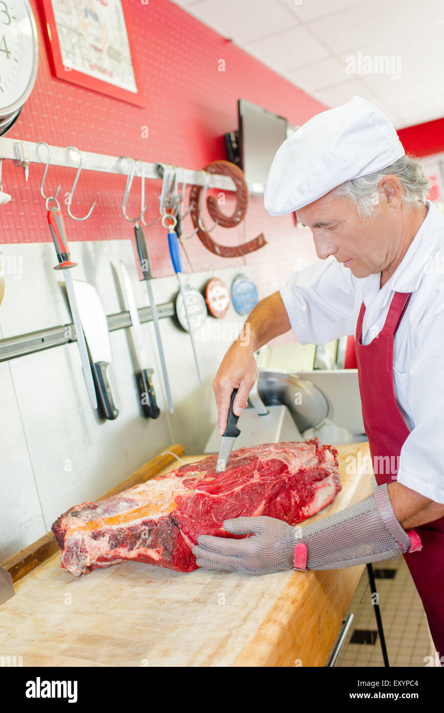 Carefully preparing a cut of beef Stock Photo - Alamy