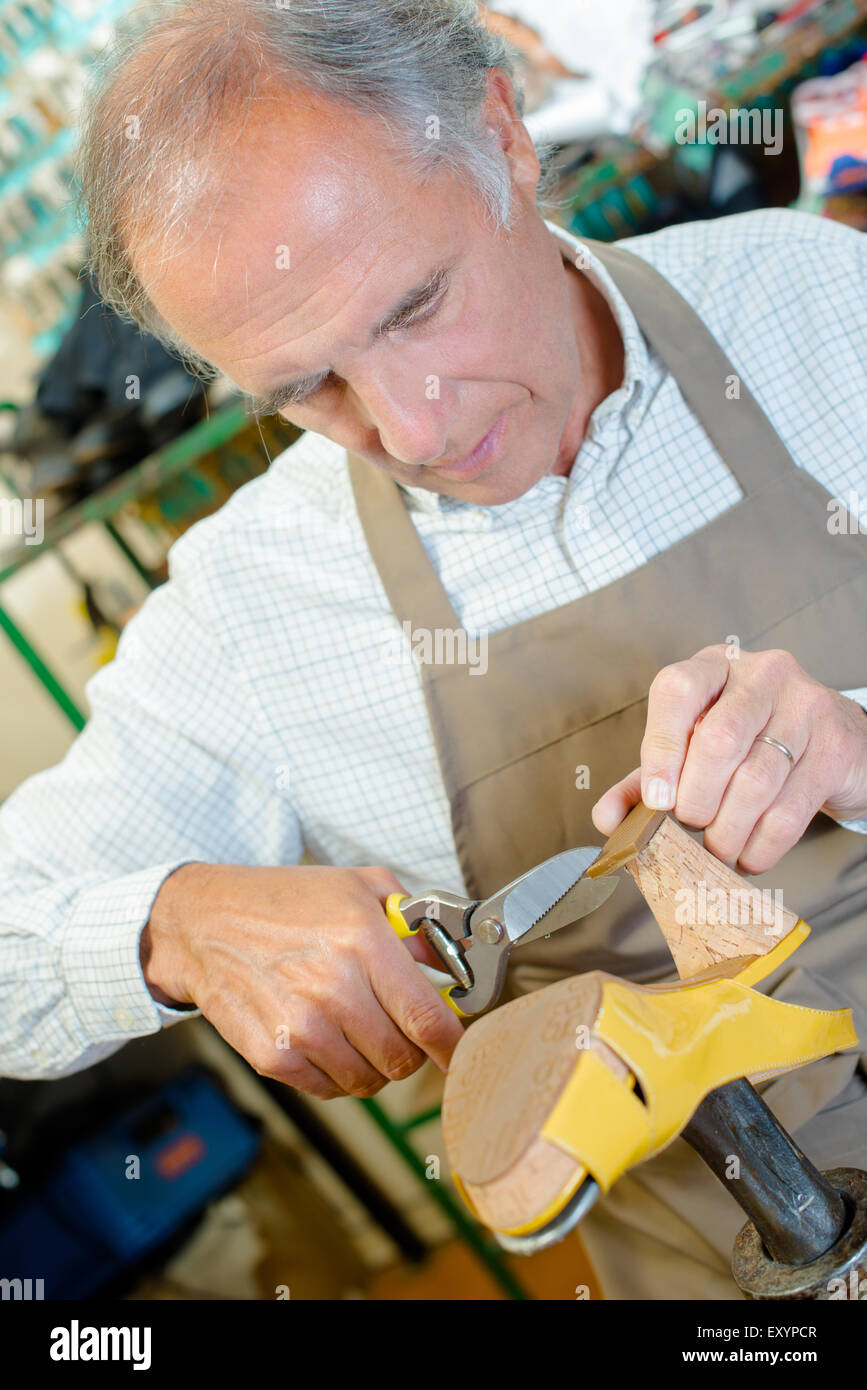 Experienced shoemaker hard at work Stock Photo - Alamy
