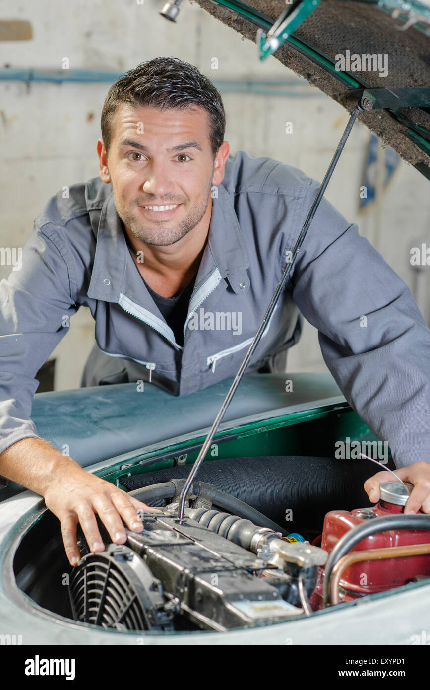 Man trying to fix his car Stock Photo - Alamy