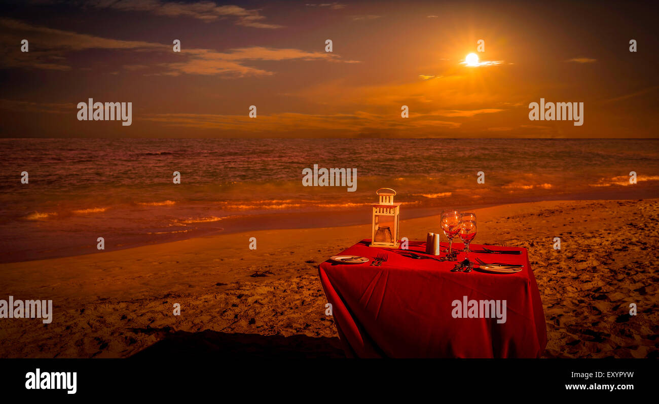 Sunset caribbean beach landscape and party table Stock Photo - Alamy
